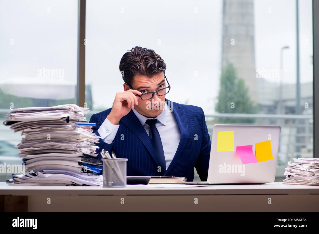 Workaholic businessman overworked with too much work in office Stock ...