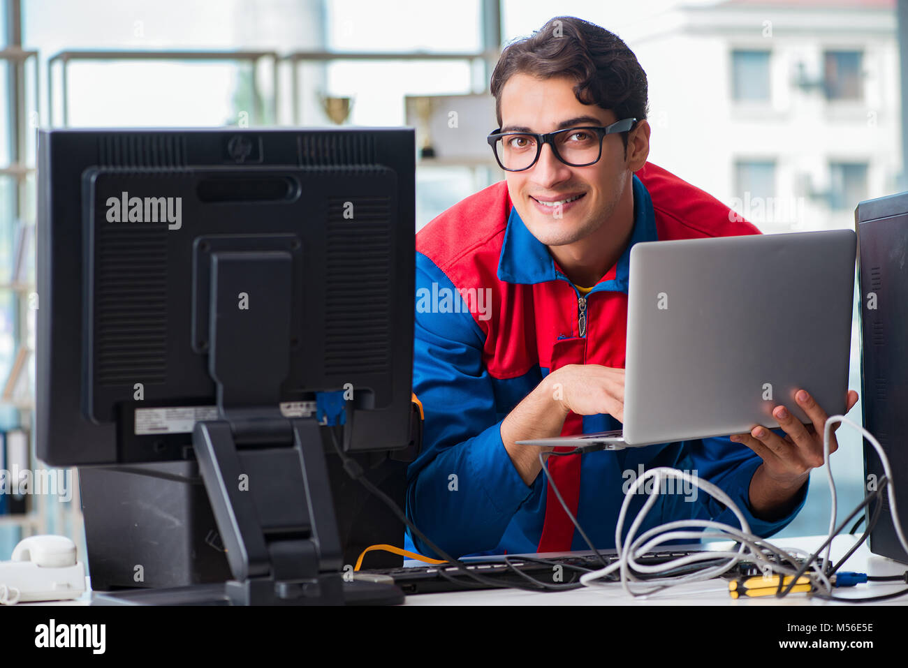 Computer repairman working on repairing computer in IT workshop Stock ...