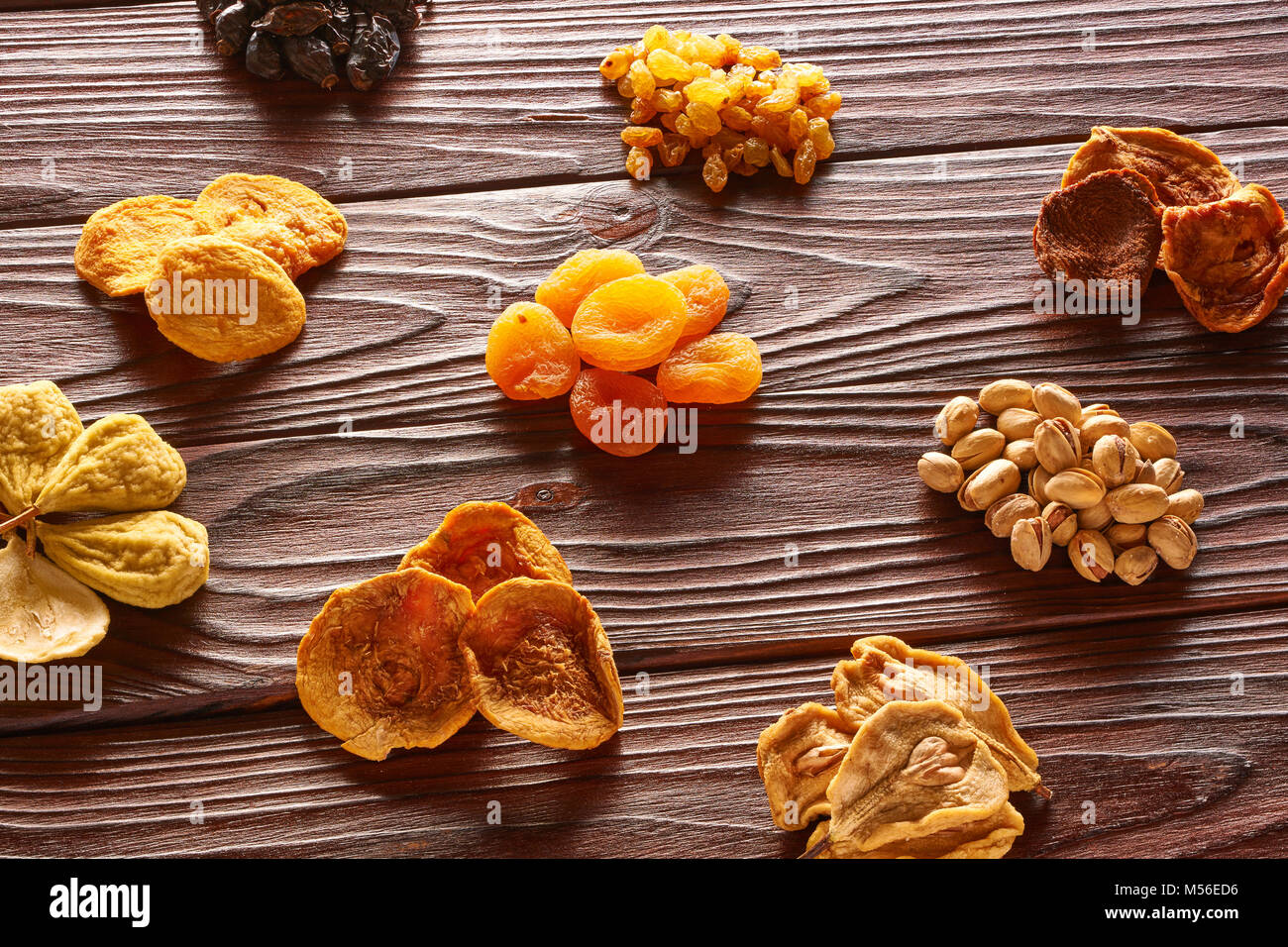 Dried fruits and nuts on wooden background Stock Photo - Alamy