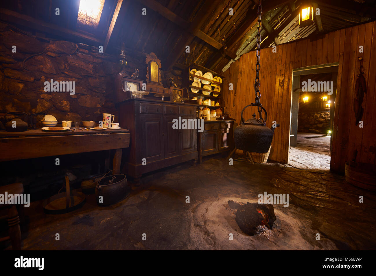 Original interior of the kitchen area with paet fire burning in The Blackhouse, 24 Arnol, Bragar ...