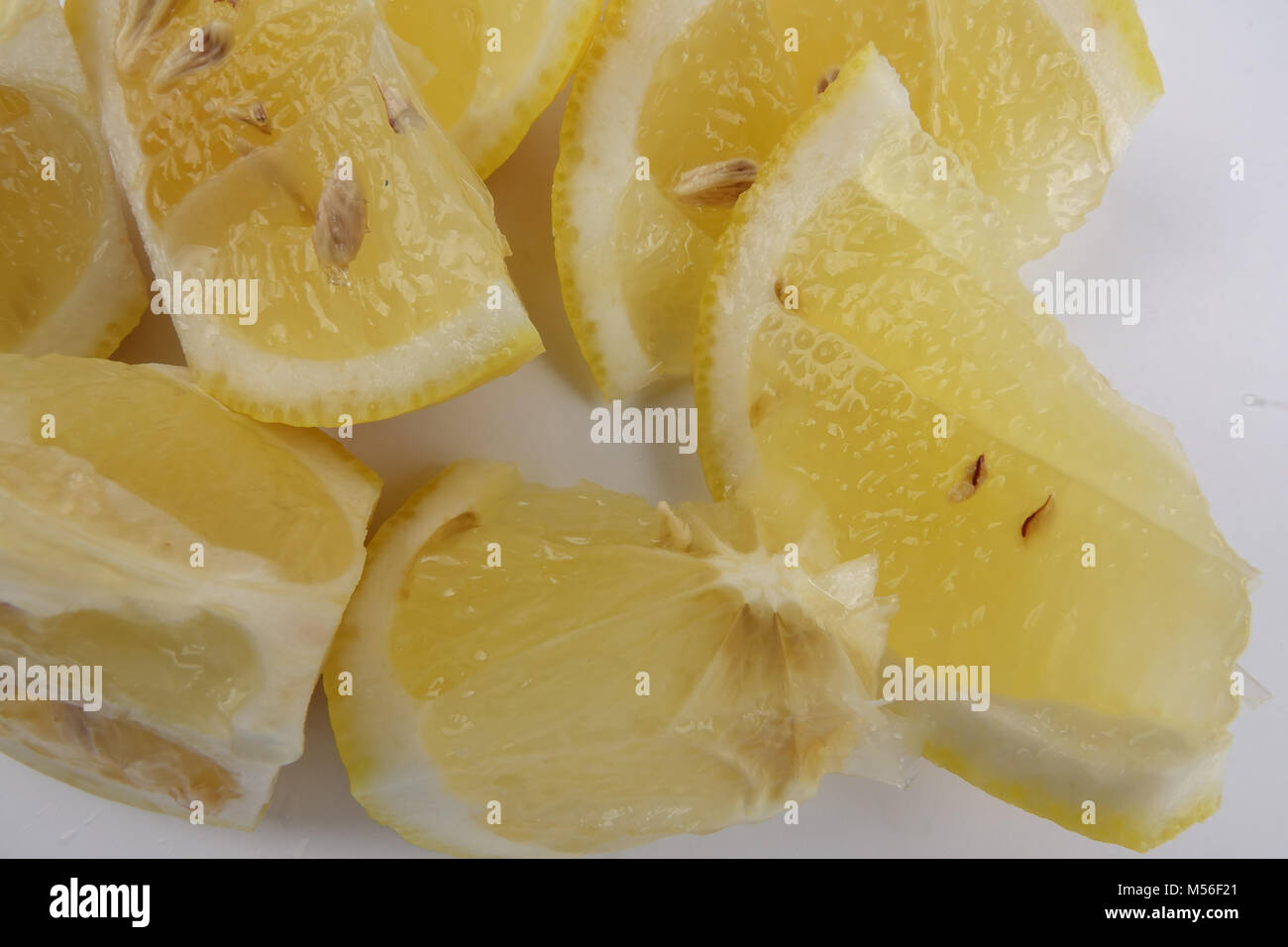 Close up of randomly cut off lemon on white background Stock Photo - Alamy
