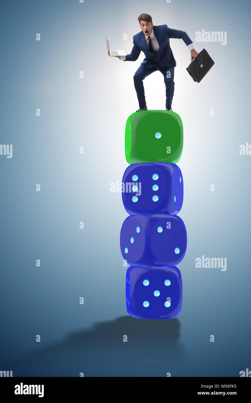 Businessman balancing on top of dice stack in uncertainty concep Stock ...