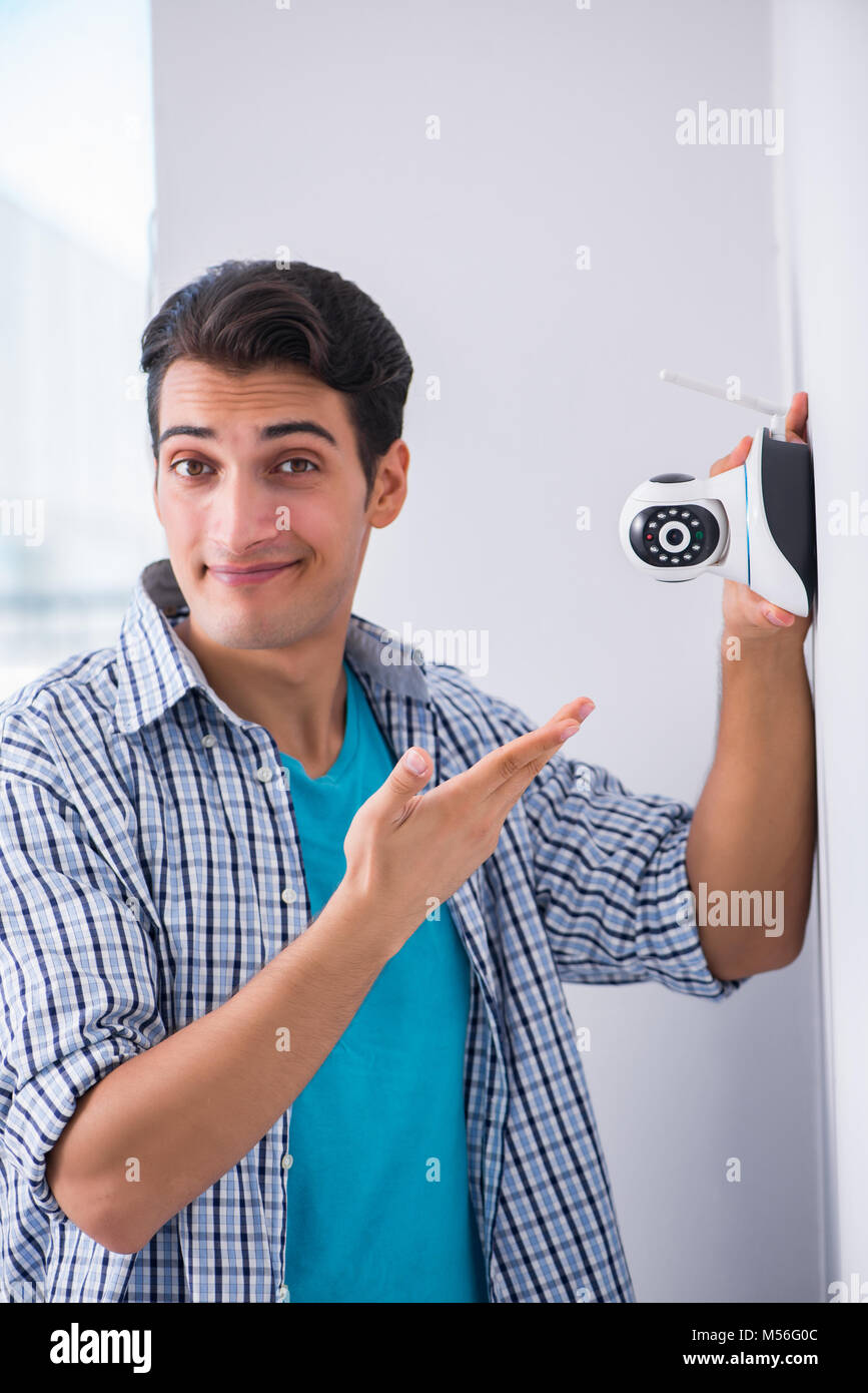 Man installing surveillance CCTV cameras at home Stock Photo - Alamy