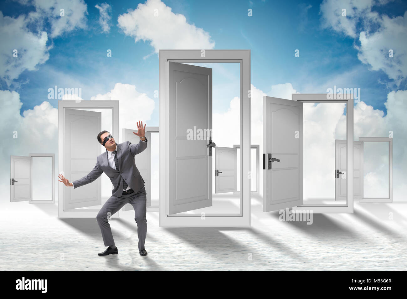 Confused businessman in front of doors Stock Photo - Alamy
