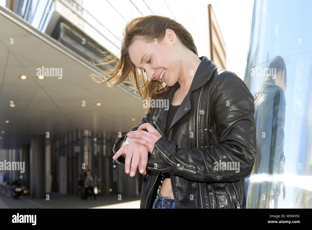 young woman looking at watch Stock Photo - Alamy