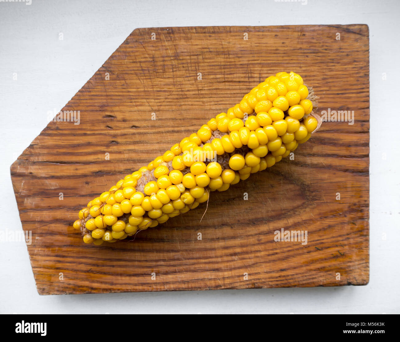 The yellow nature corn isolated on a wood background Stock Photo - Alamy