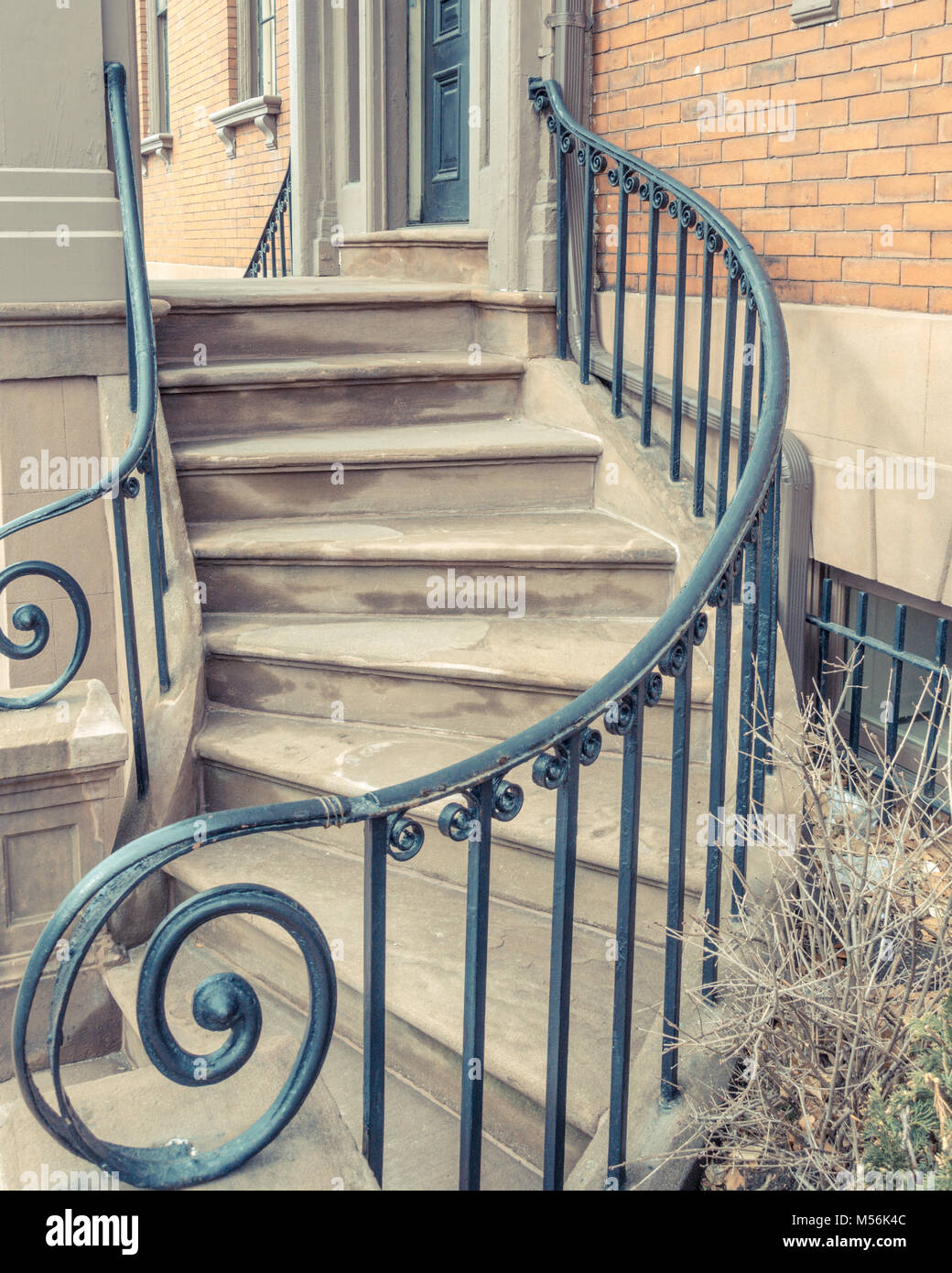 Steps and railing leading up to an old Brownstone building in ...