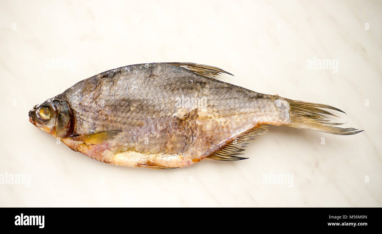 The Dried Fish Bream on a color background Stock Photo - Alamy