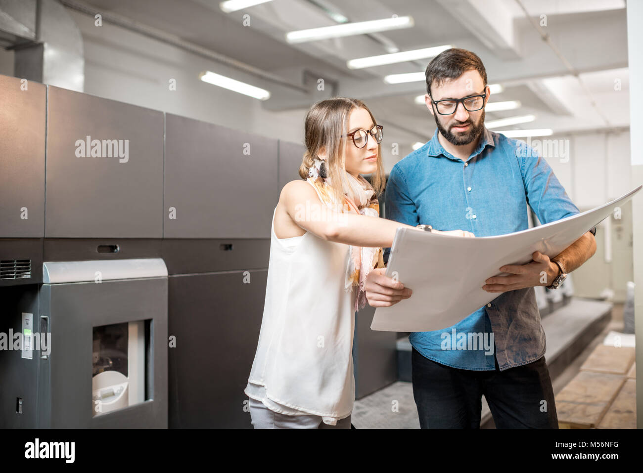 Woman with print operator at the manufacturing Stock Photo - Alamy