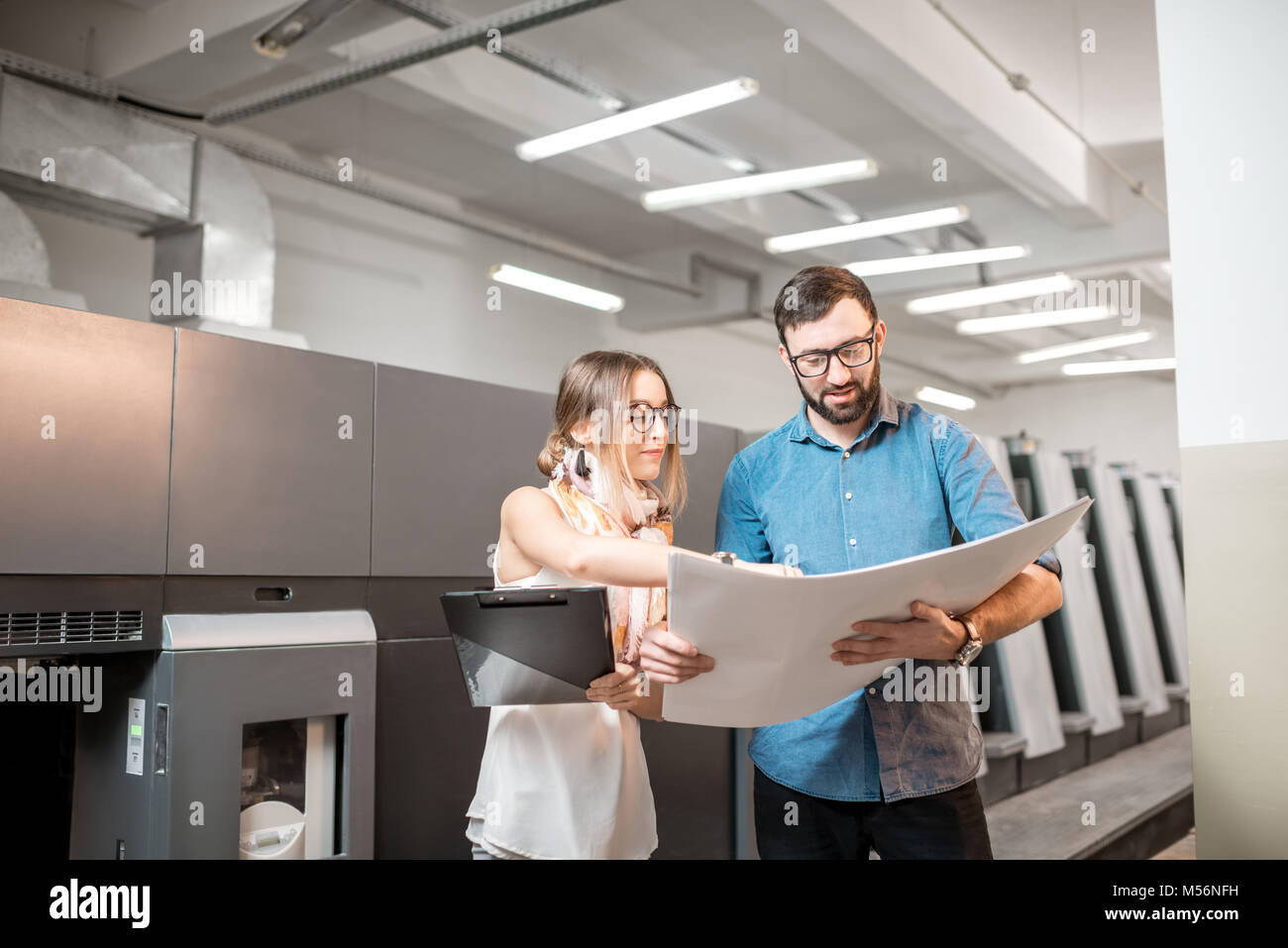 Woman with print operator at the manufacturing Stock Photo - Alamy