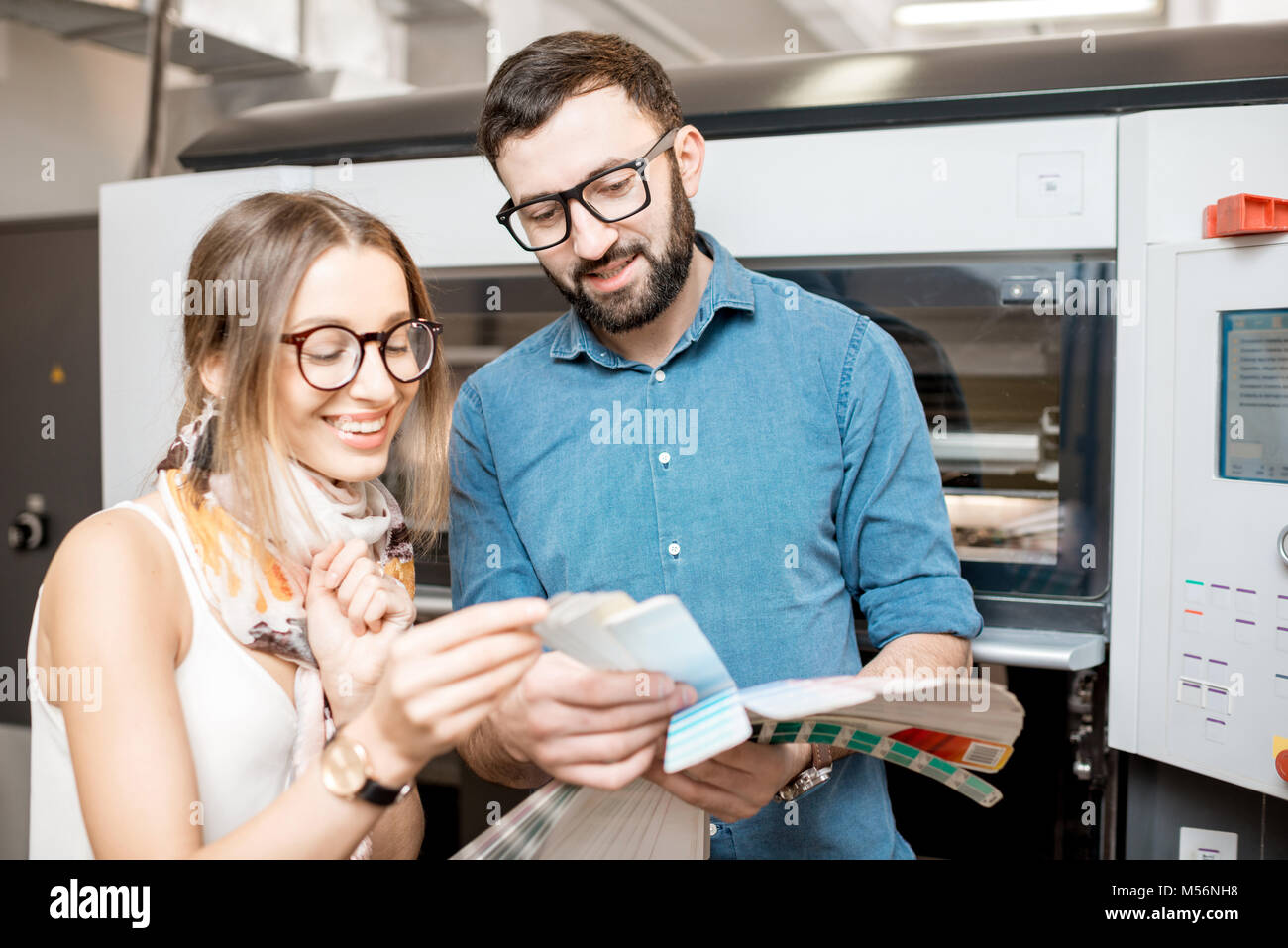 Woman with print operator at the manufacturing Stock Photo - Alamy