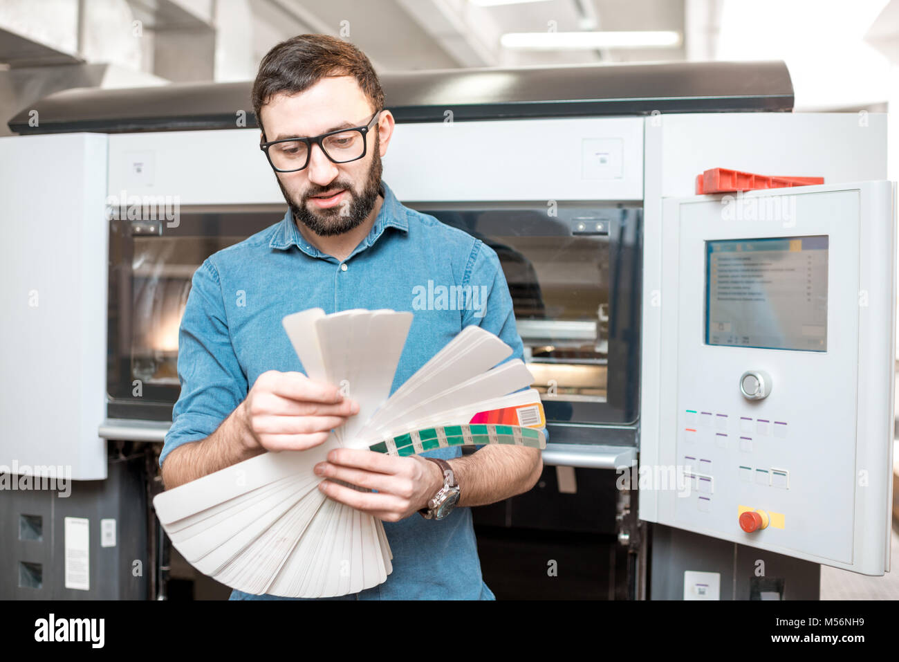 Typographer with color swatches at the manufacturing Stock Photo - Alamy