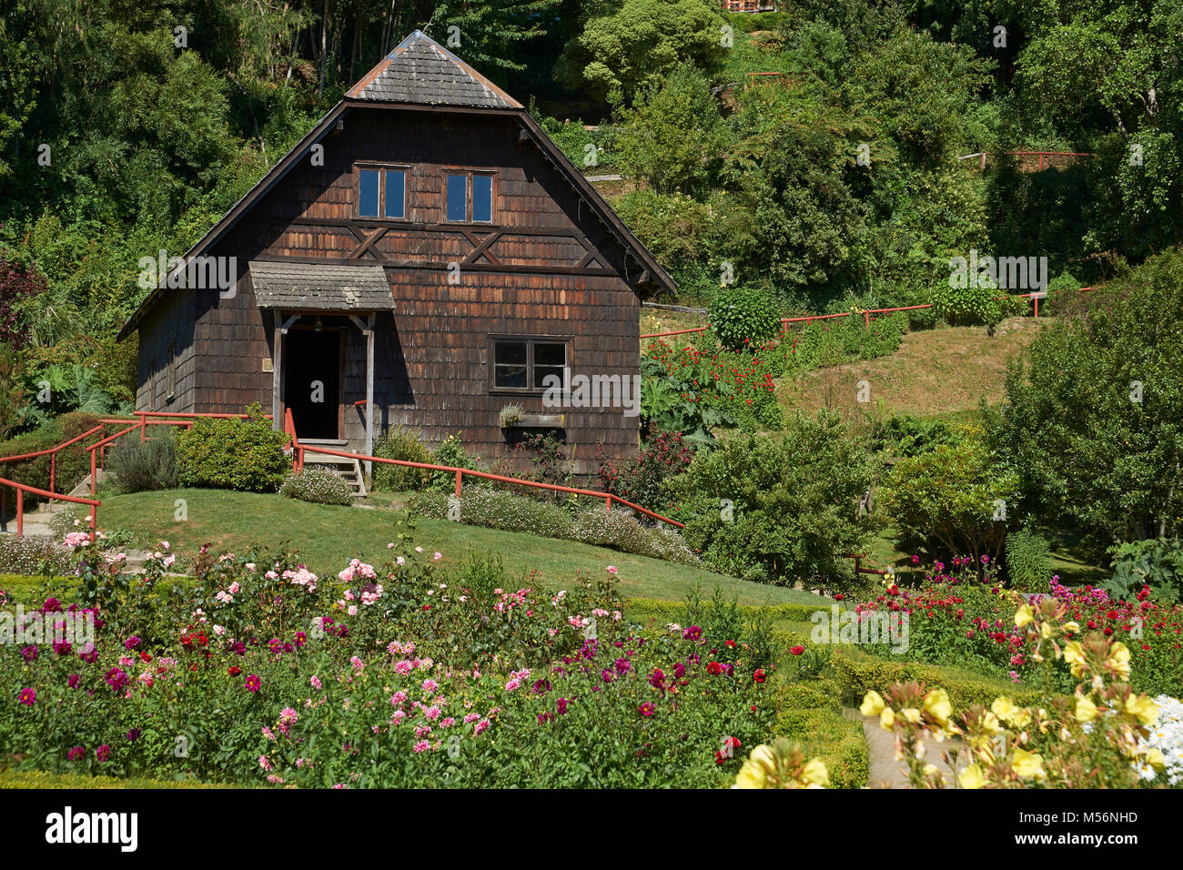 Traditional wooden farm buildings set in the landscaped gardens of the ...