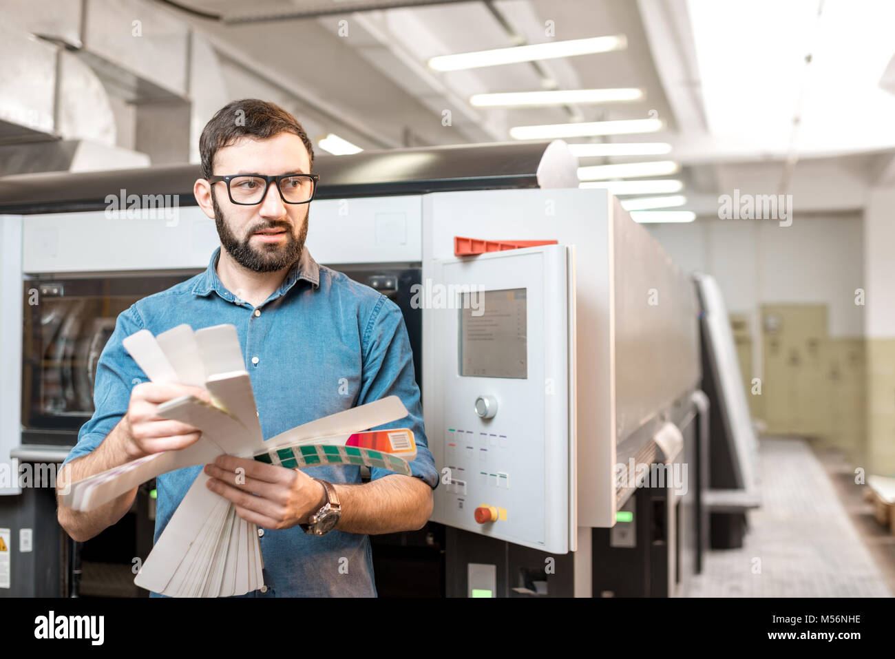 Typographer with color swatches at the manufacturing Stock Photo - Alamy
