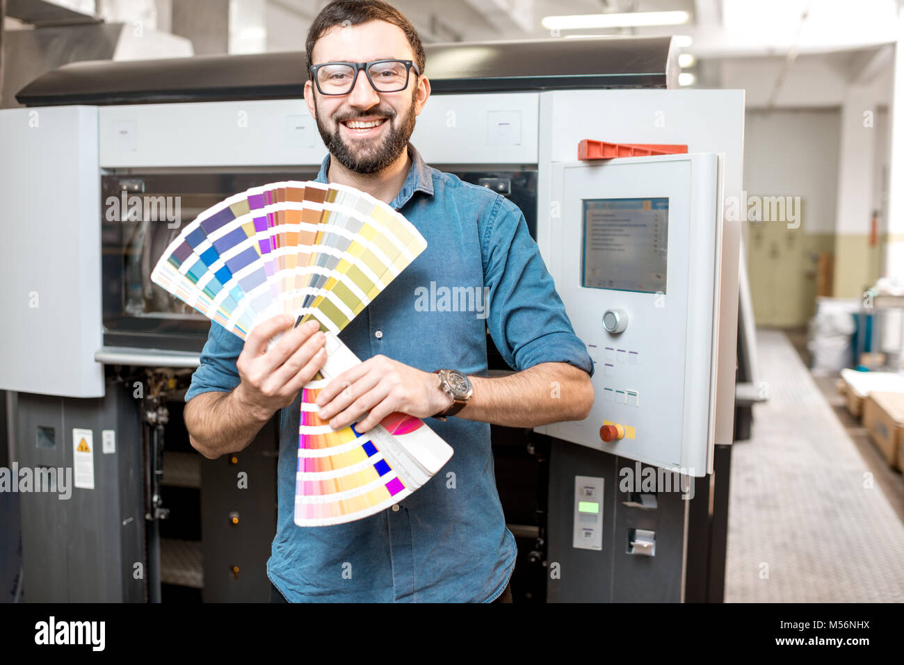 Typographer with color swatches at the manufacturing Stock Photo - Alamy