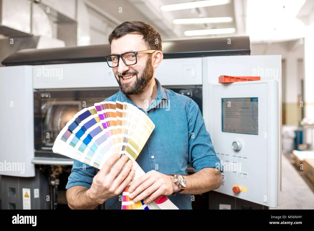 Typographer with color swatches at the manufacturing Stock Photo - Alamy