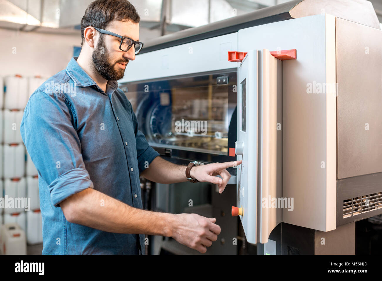 Printing operator working at the manufacturing Stock Photo - Alamy