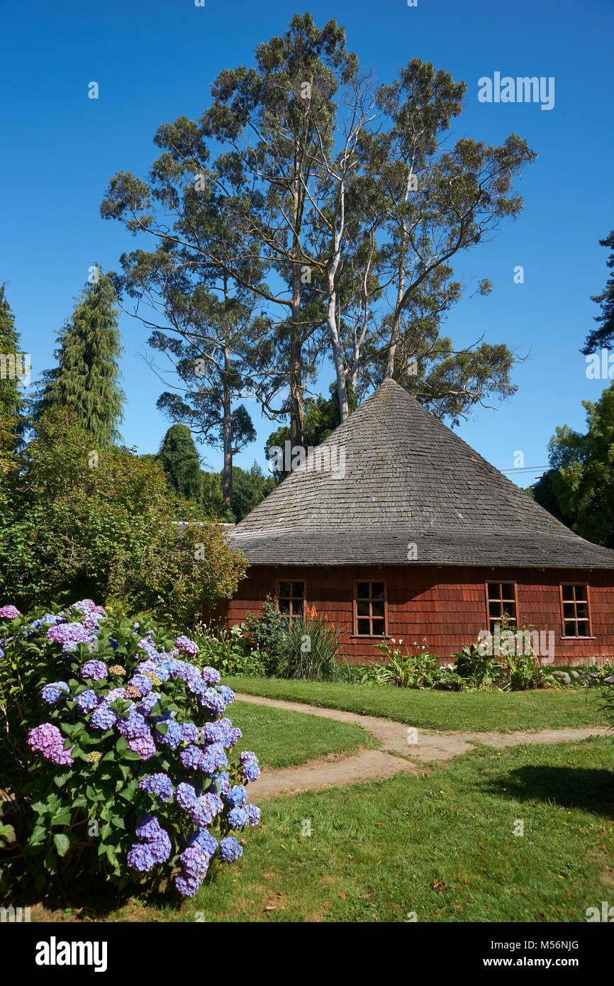 Traditional wooden farm buildings set in the landscaped gardens of the ...