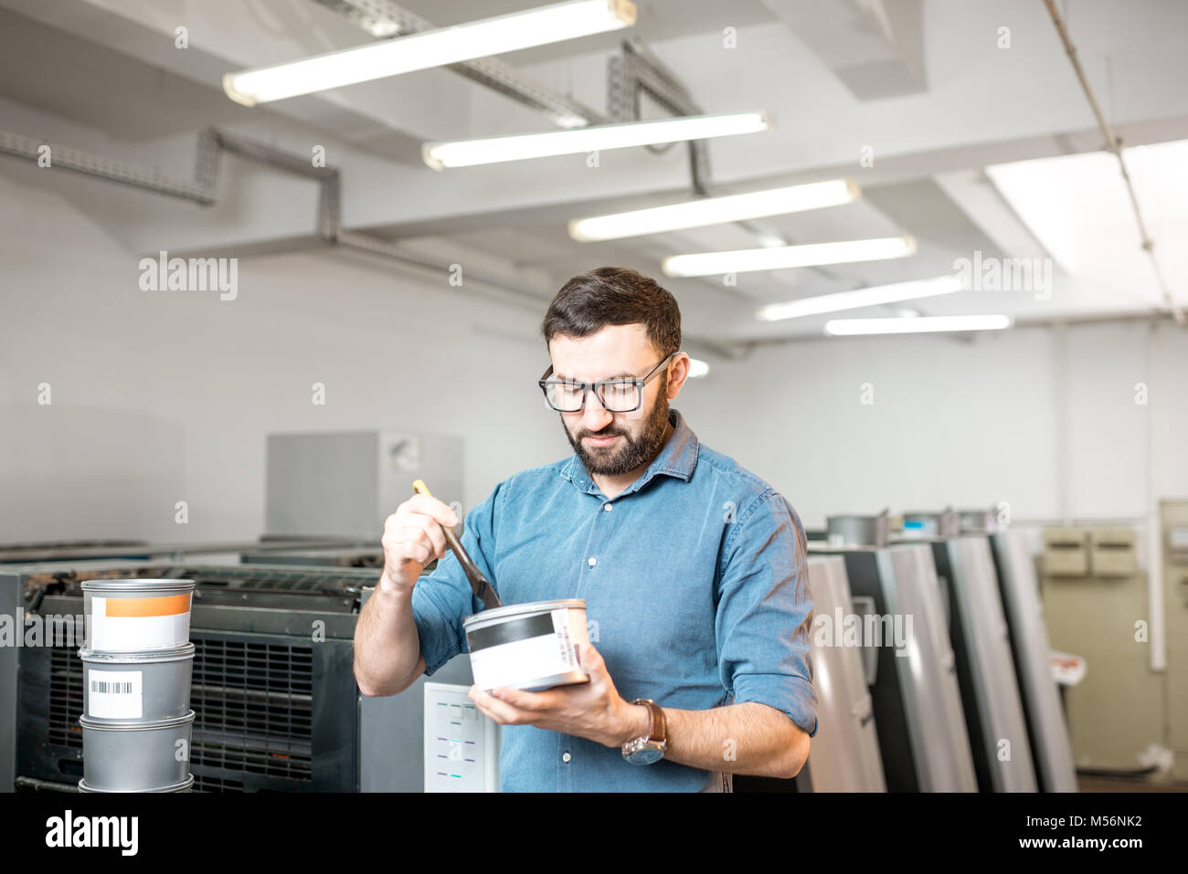 Typographer with paint at the manufacturing Stock Photo - Alamy
