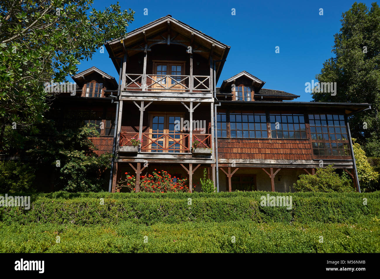 Traditional wooden farm buildings set in the landscaped gardens of the ...