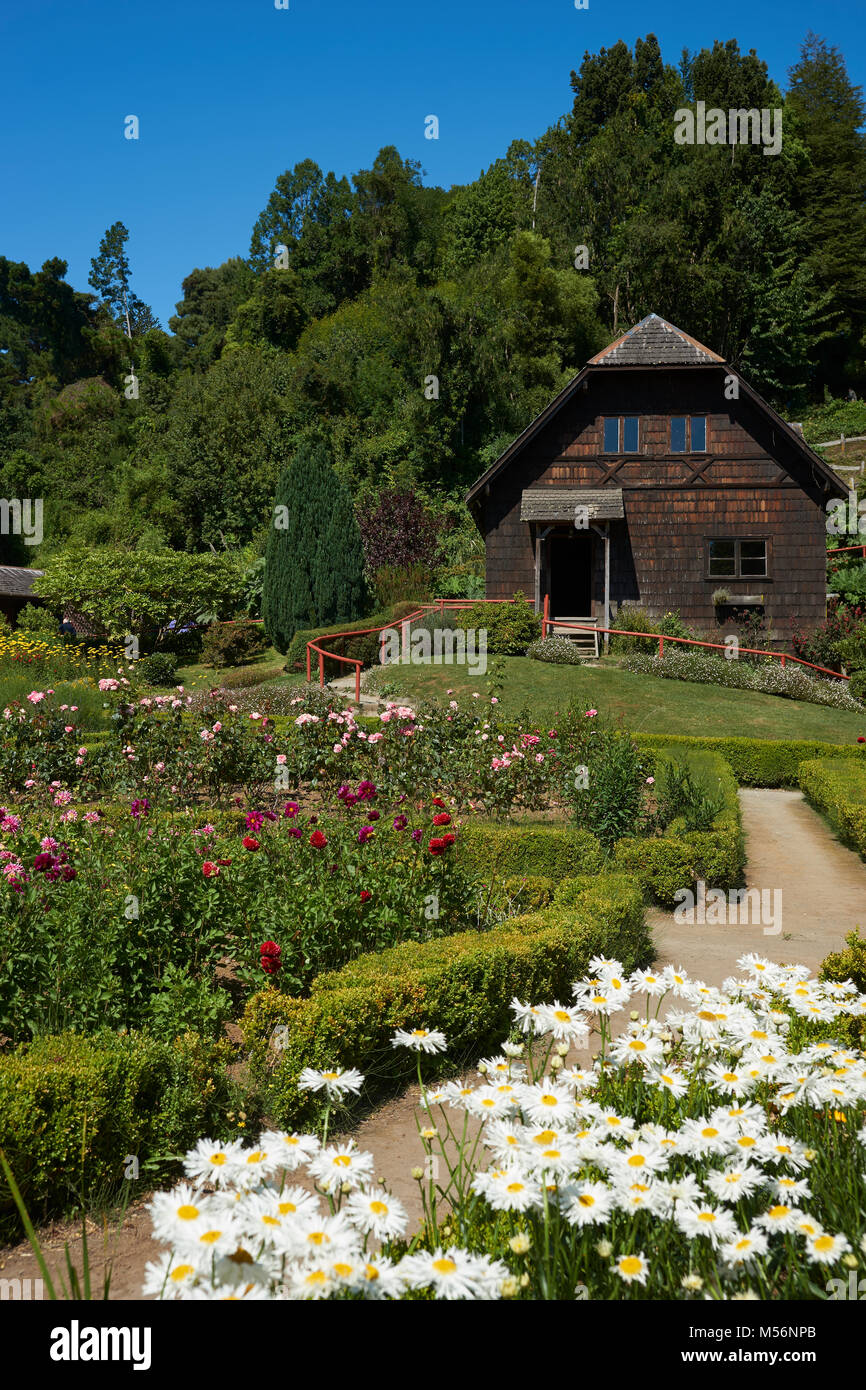 Traditional wooden farm buildings set in the landscaped gardens of the ...