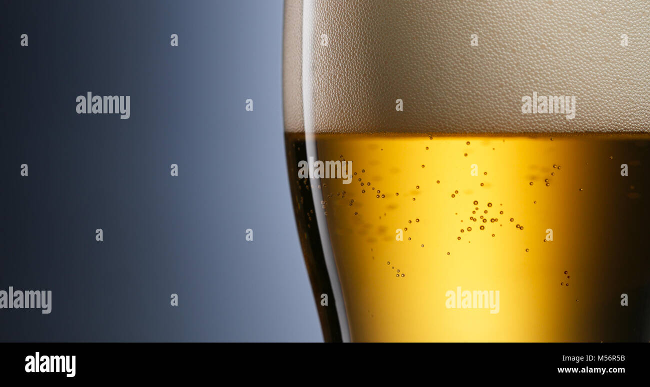 Concept of alcohol abuse and health problems. Pint of lager beer being ...