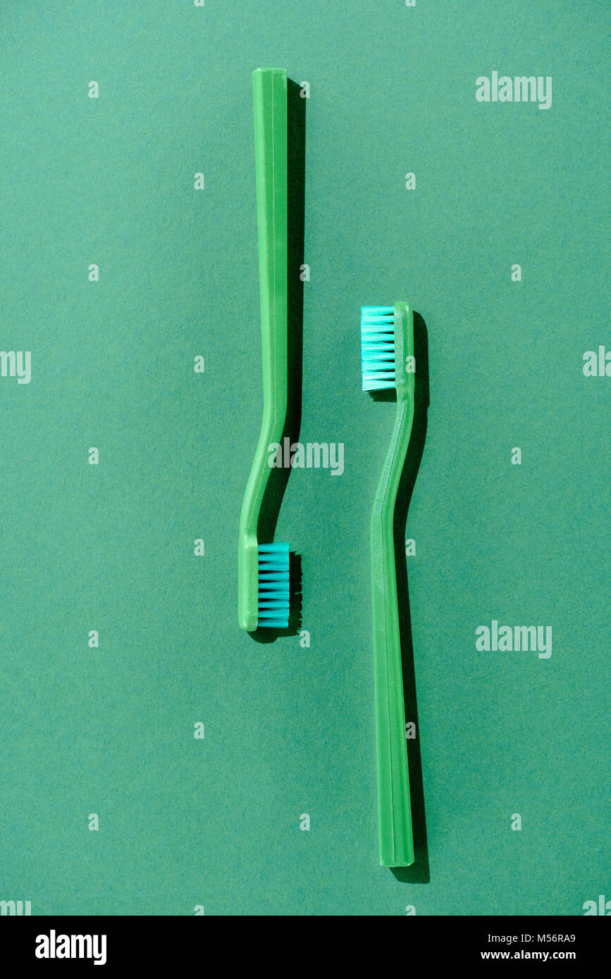 top view of green toothbrushes, on green Stock Photo - Alamy