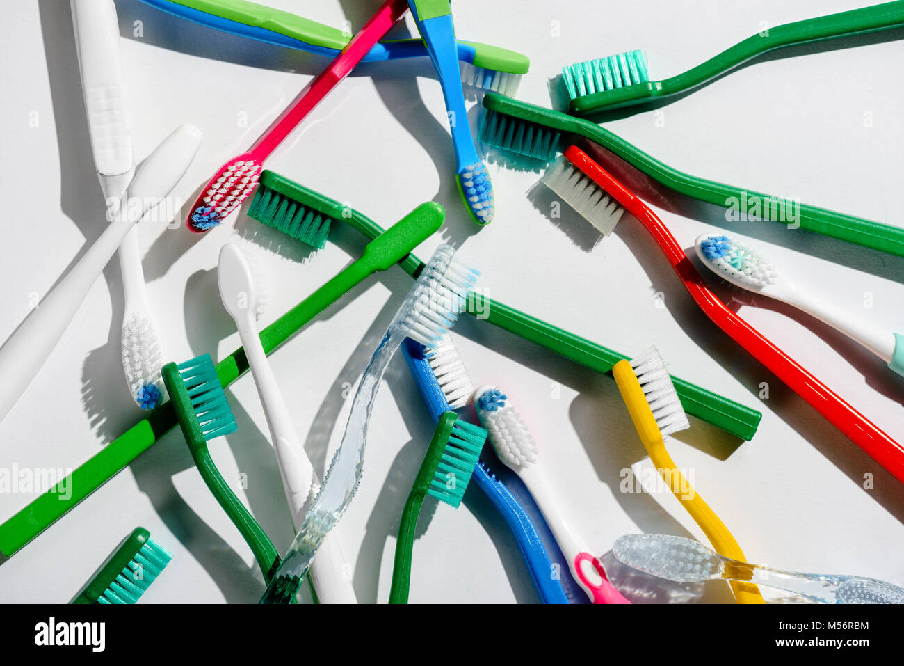 background with colorful toothbrushes for morning hygiene, on white ...