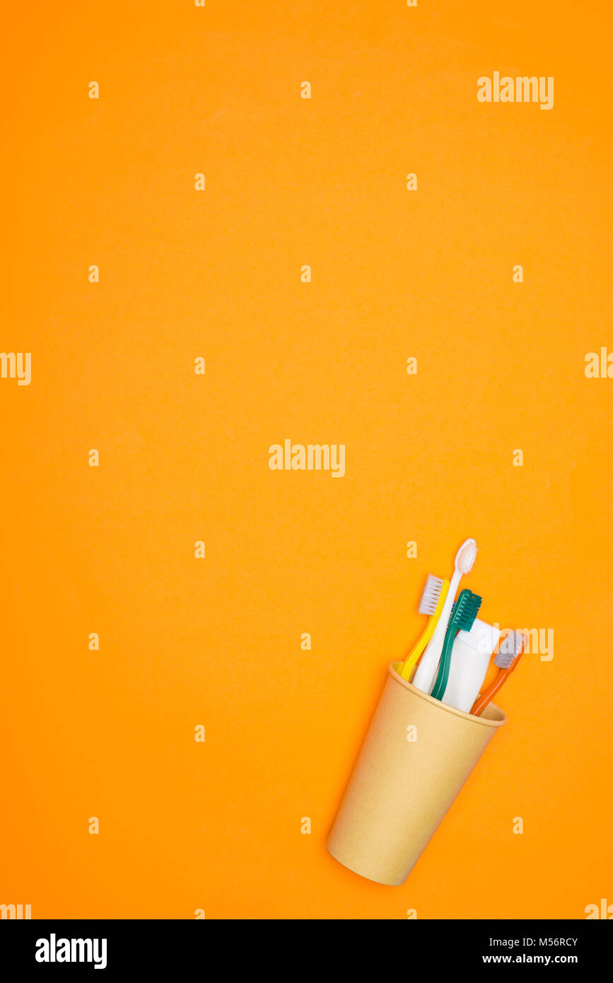 top view of toothbrushes and toothpaste in paper cup, isolated on ...