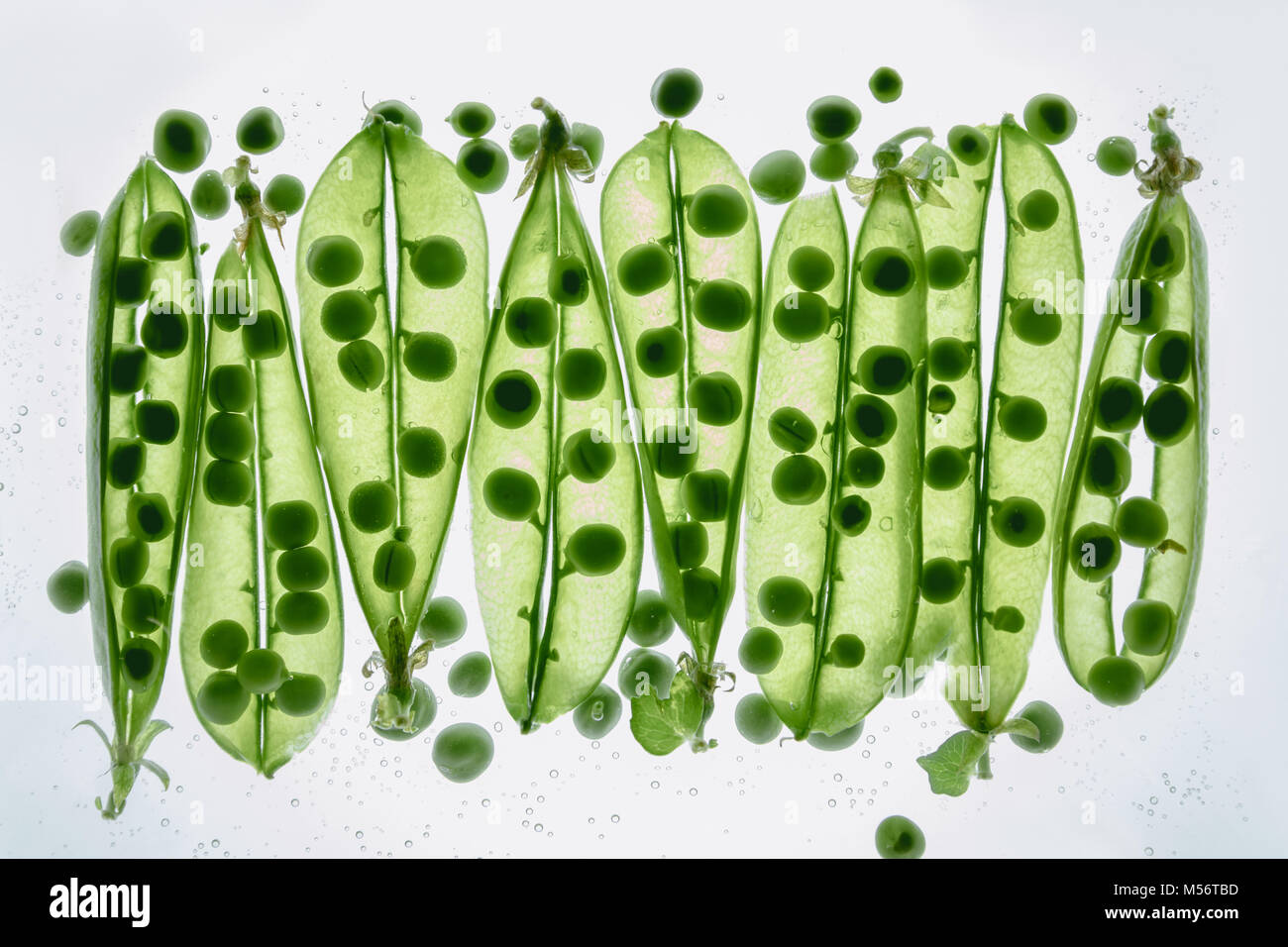 green peas floating in water Stock Photo - Alamy