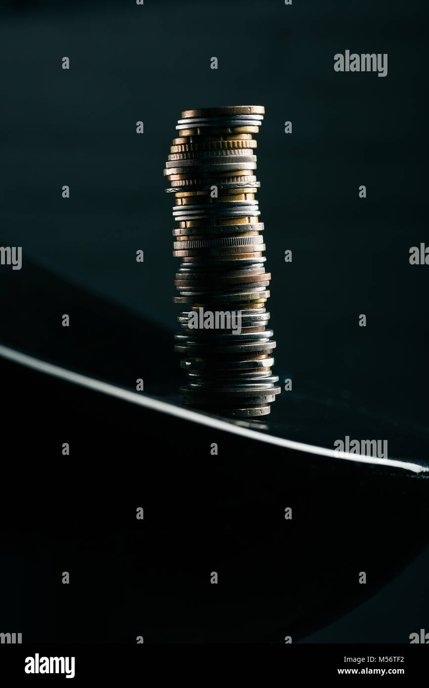 close up view of stack of different coins standing on edge of table ...