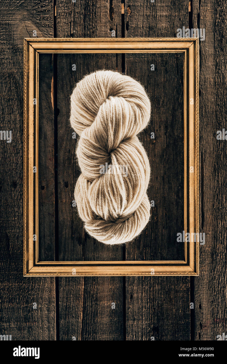 top view of white knitting yarn with frame on wooden background Stock ...