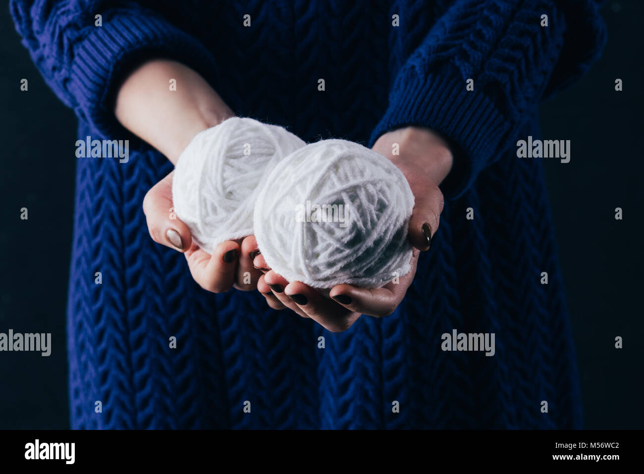 cropped view of woman holding white wool balls Stock Photo - Alamy