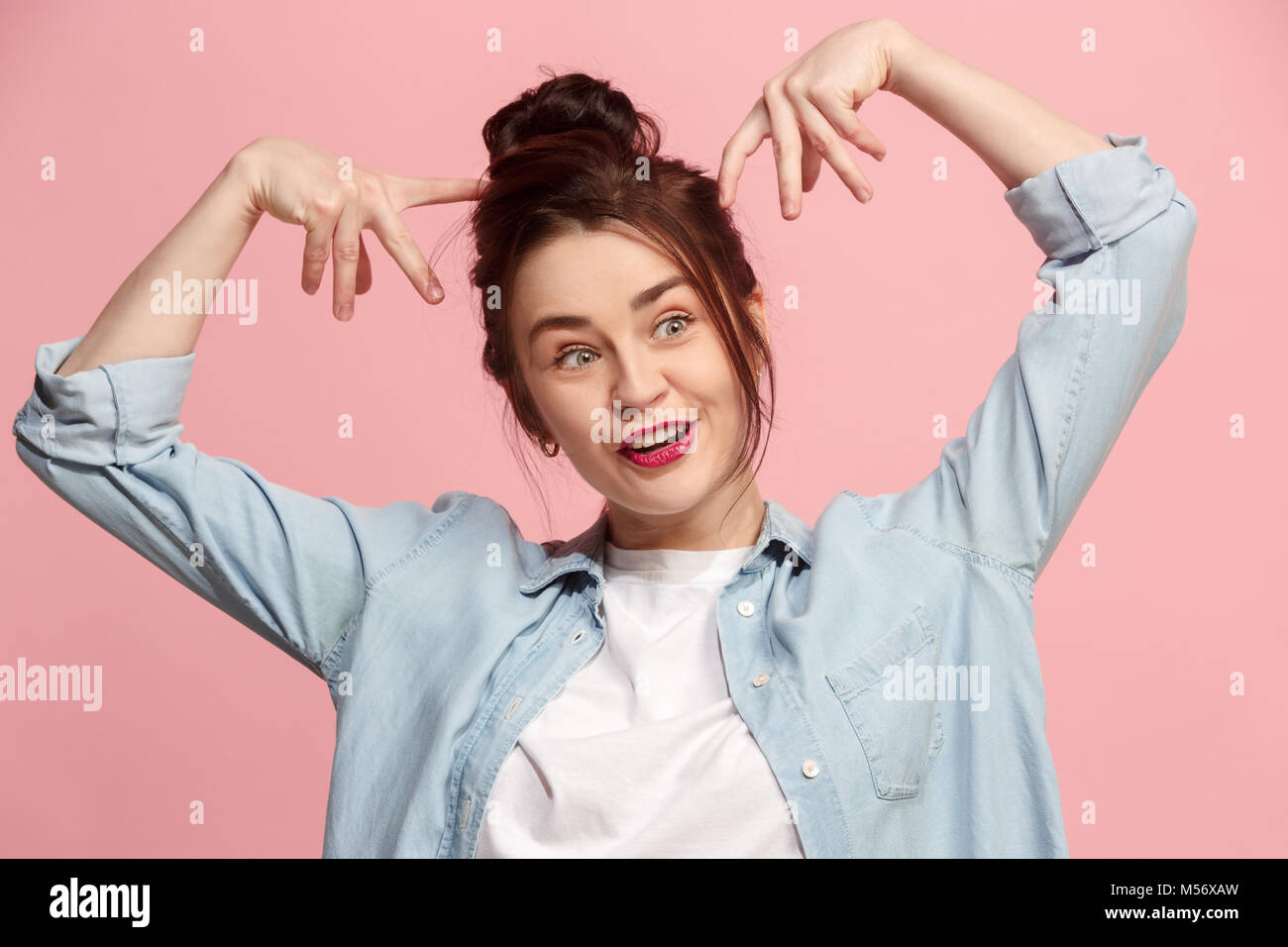 The squint eyed woman with weird expression isolated on pink Stock ...