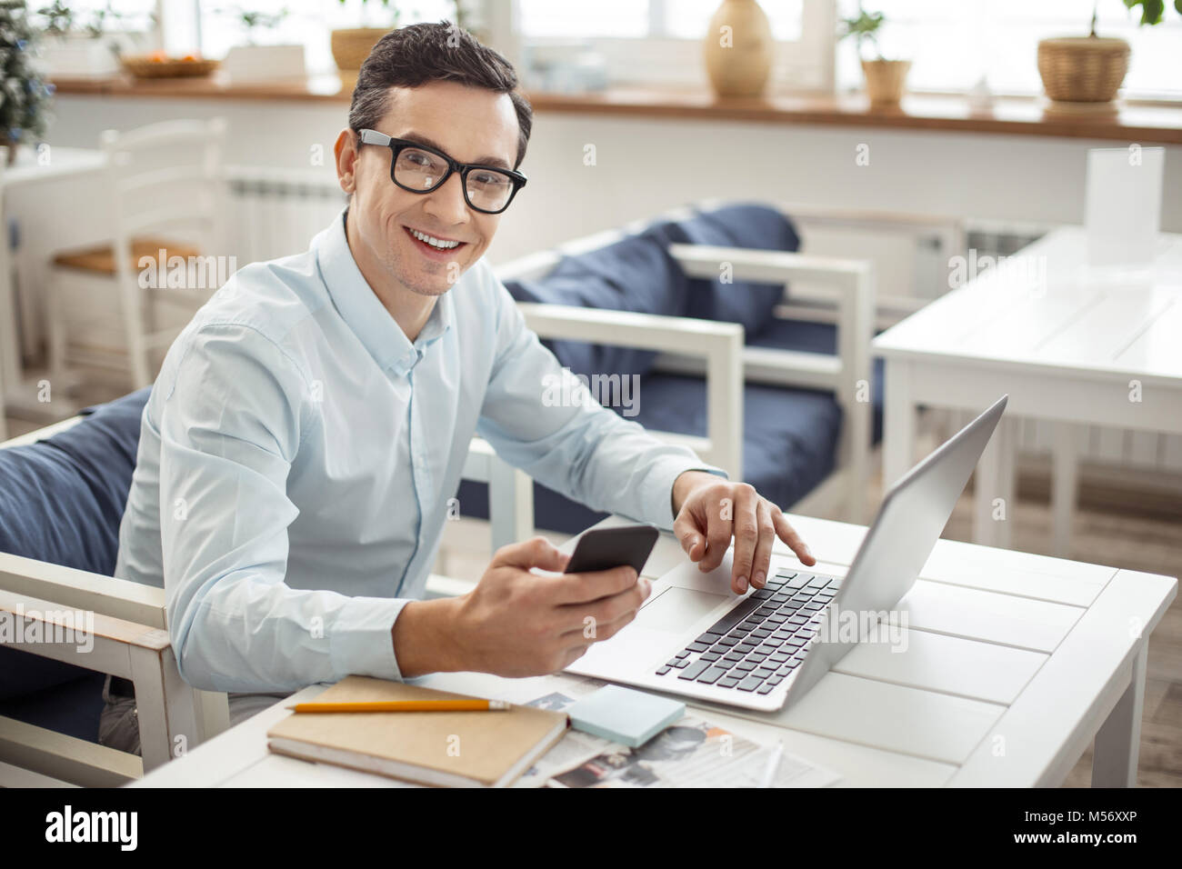 Happy freelancer working in a cafe Stock Photo - Alamy