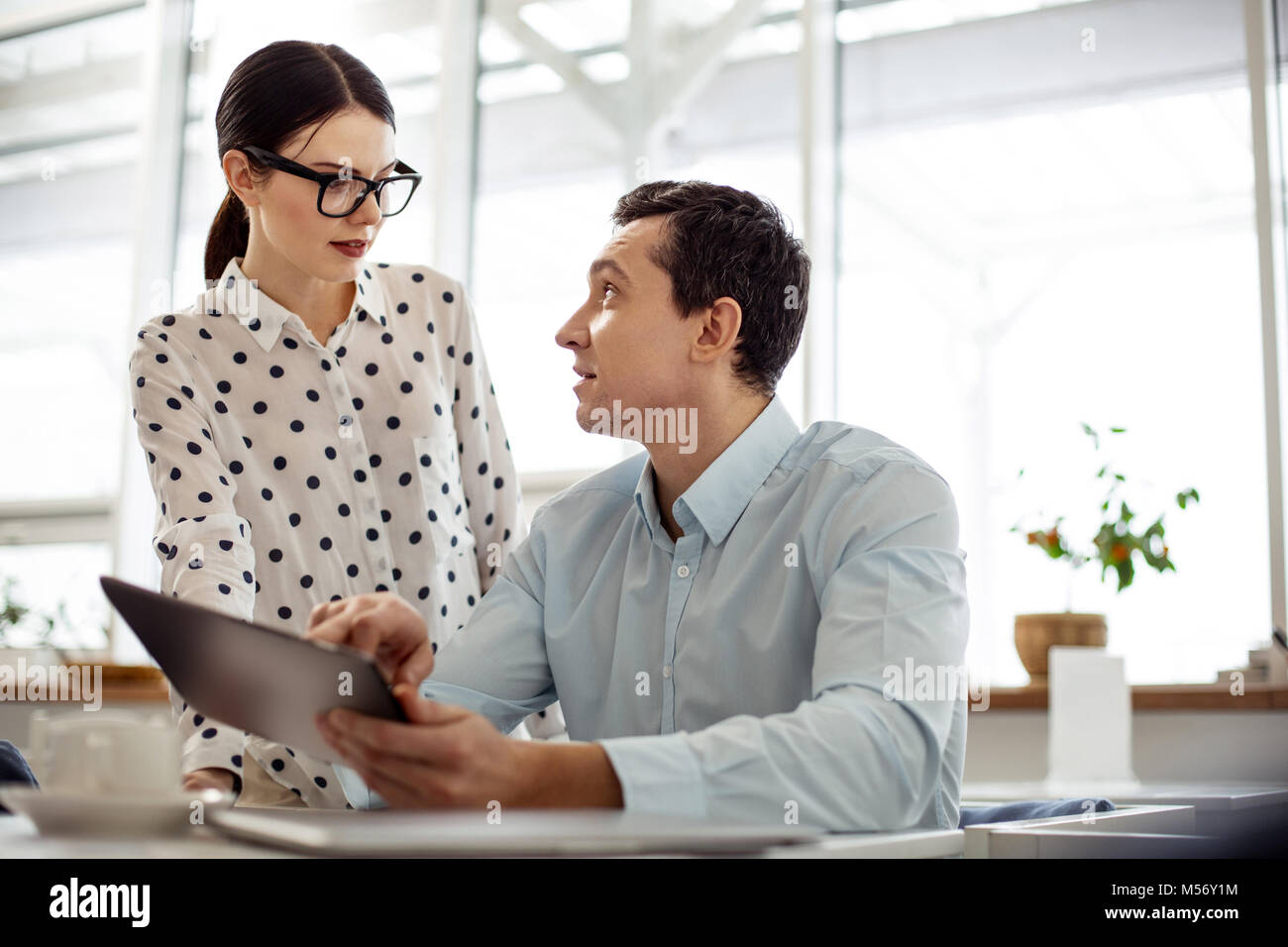 Adorable woman talking with her partner Stock Photo - Alamy