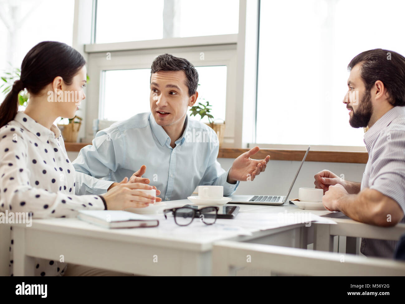 Happy business partners discussing their business Stock Photo - Alamy