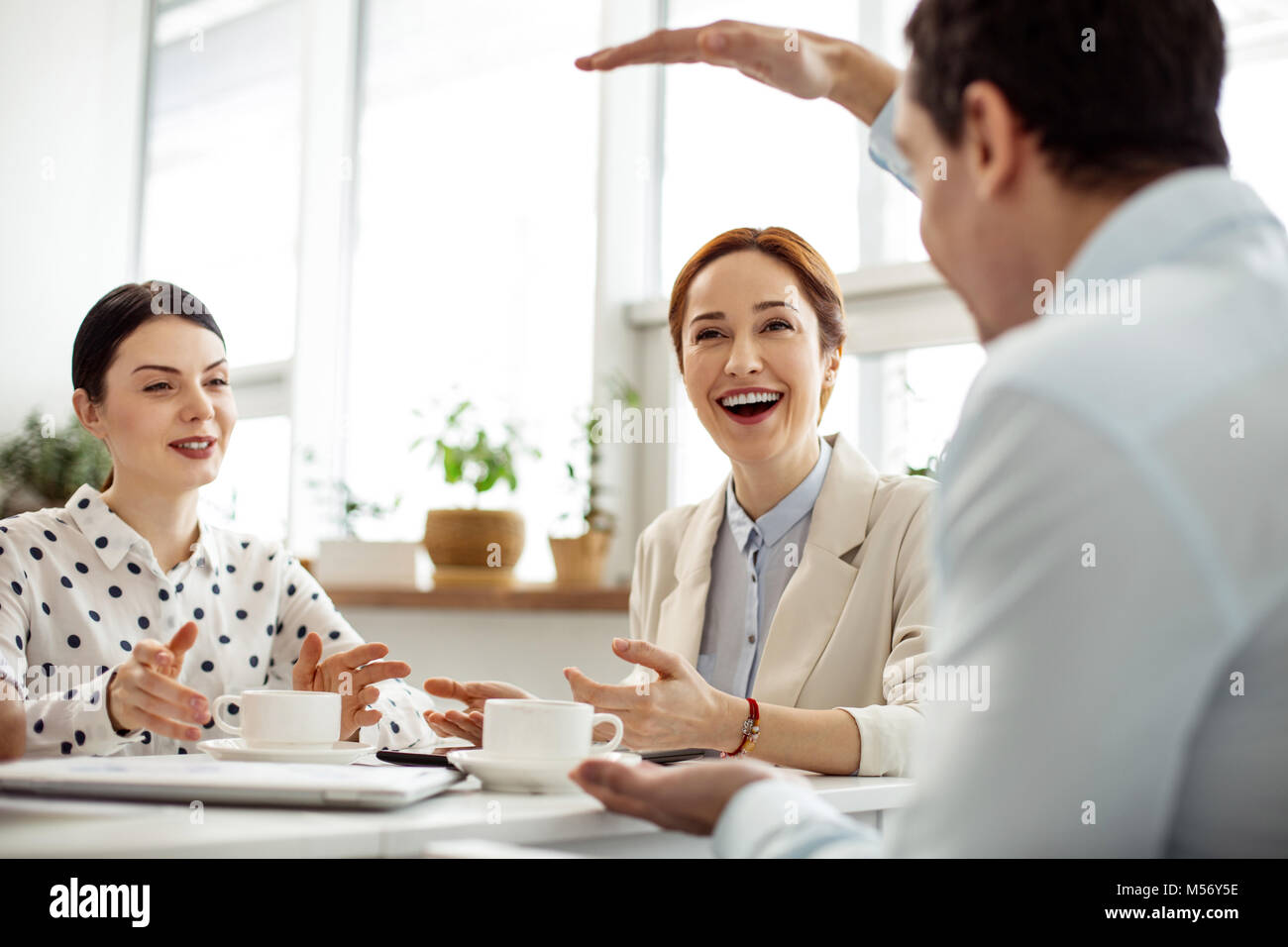 Cheerful best friends having coffee together Stock Photo - Alamy