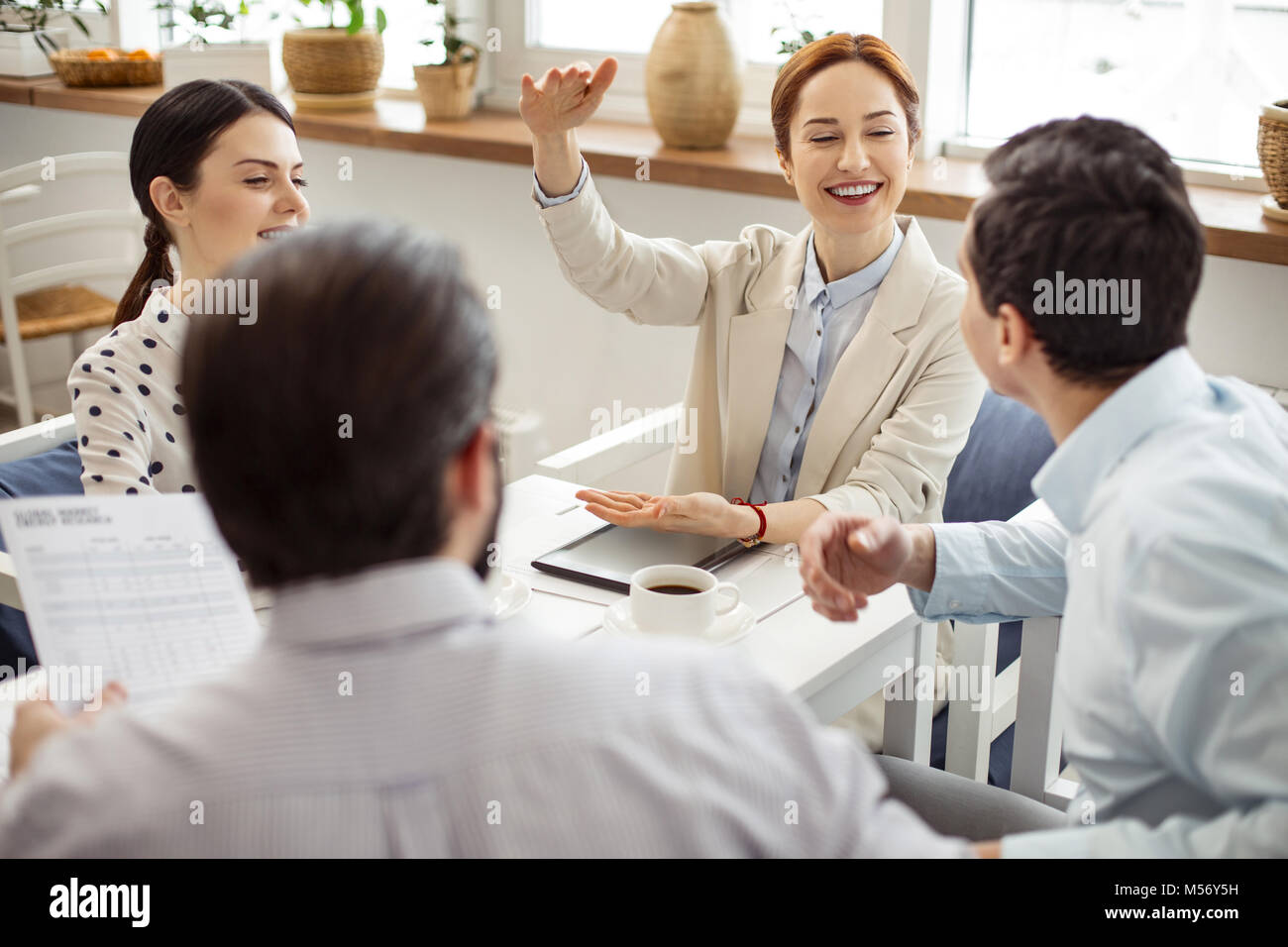 Happy woman telling a story to her friends Stock Photo - Alamy