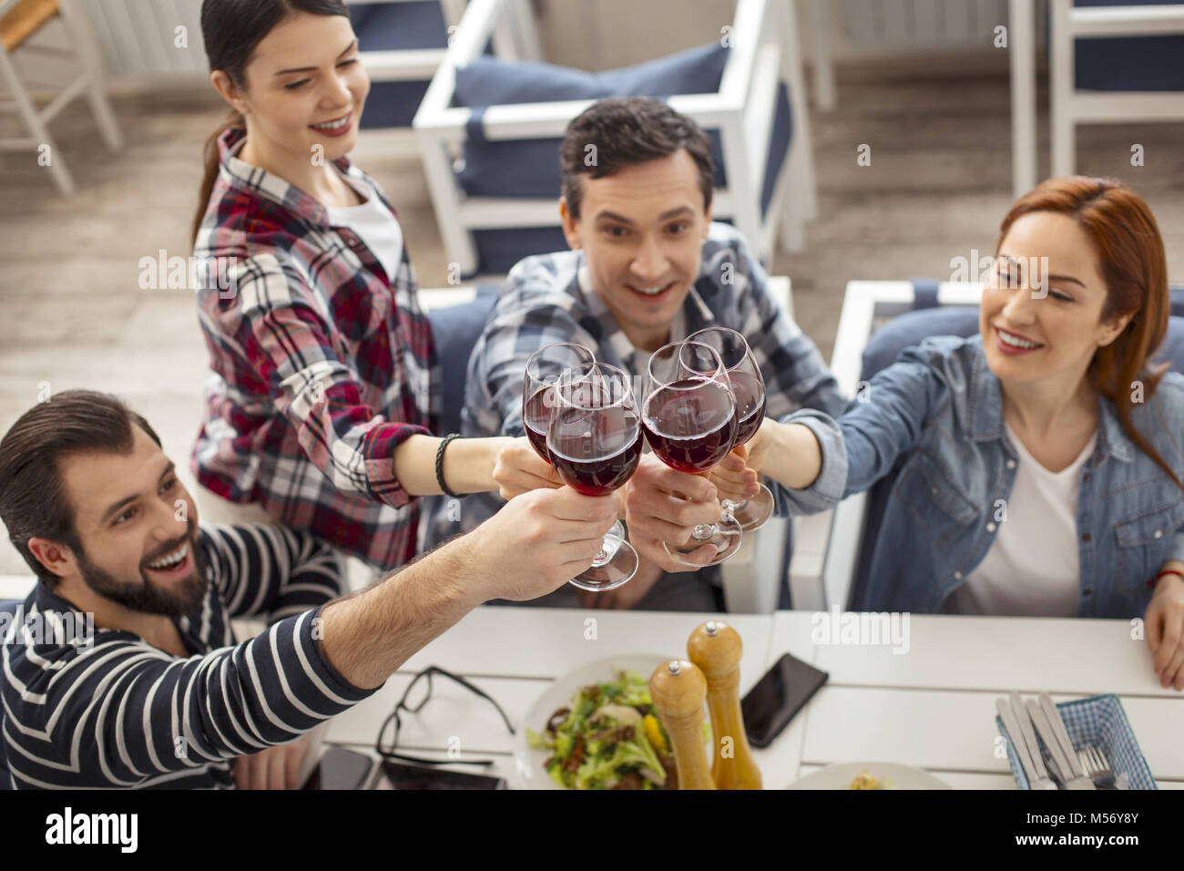 Smiling best friends clanging glasses Stock Photo - Alamy