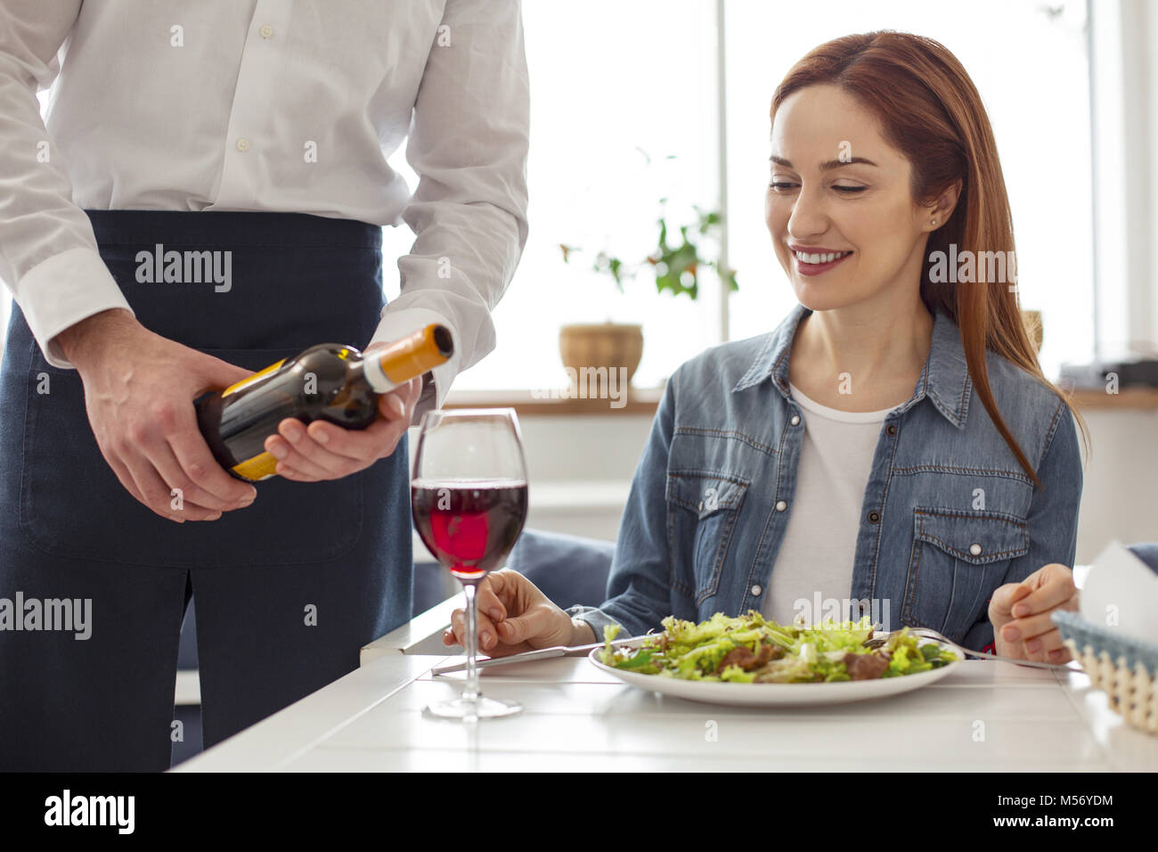 Cheerful woman having dinner in a restaurant Stock Photo - Alamy