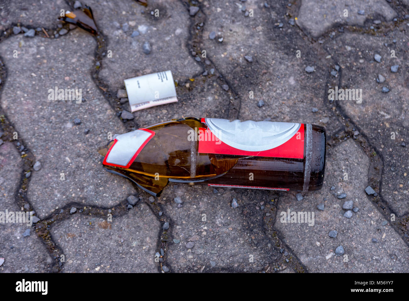 broken beer bottles in the middle of the footpath Stock Photo - Alamy