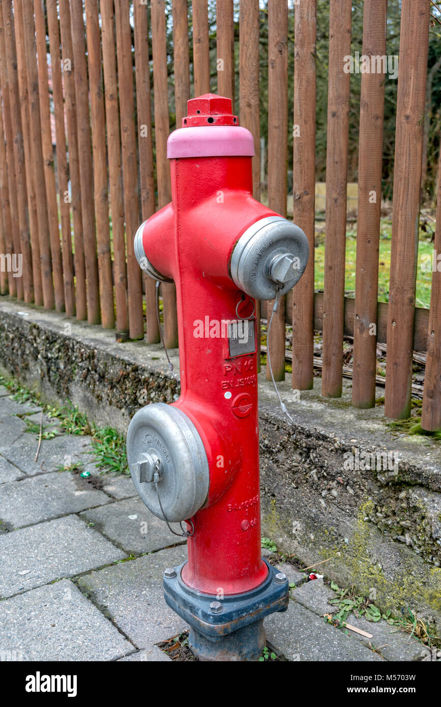 Red water hydrant in the middle of the footpath Stock Photo - Alamy