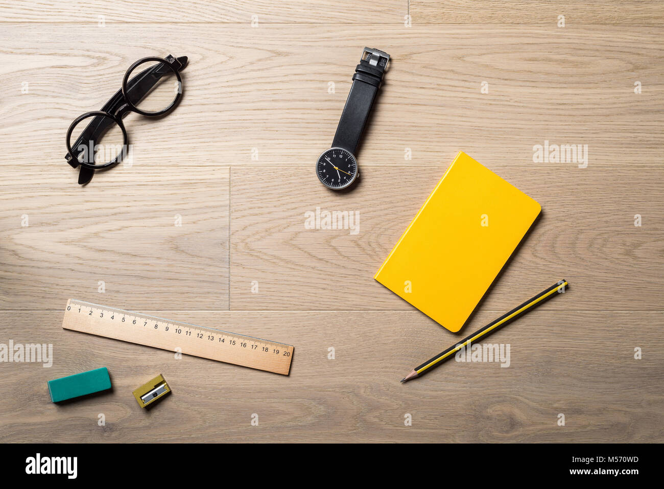 Gathering of office objects such as yellow notebook, ruler, pencil and ...