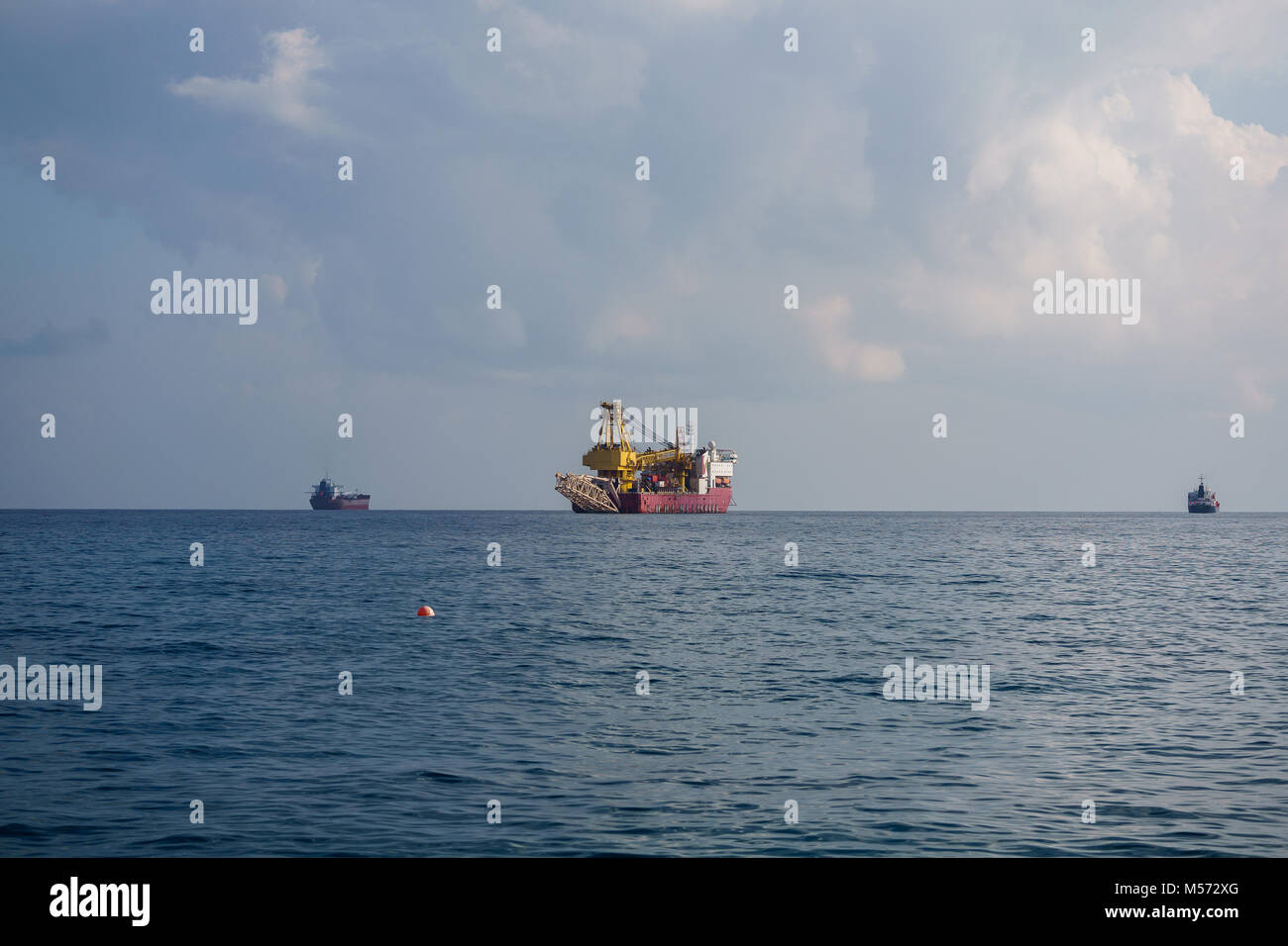 Photo of sea with floating cargo ship Stock Photo - Alamy