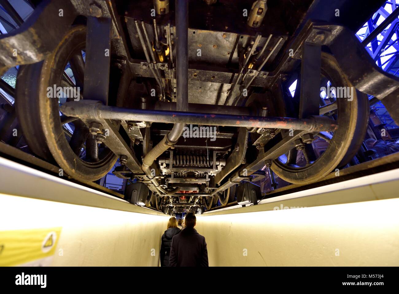 People walking underneath an old steam locomotive in the National ...