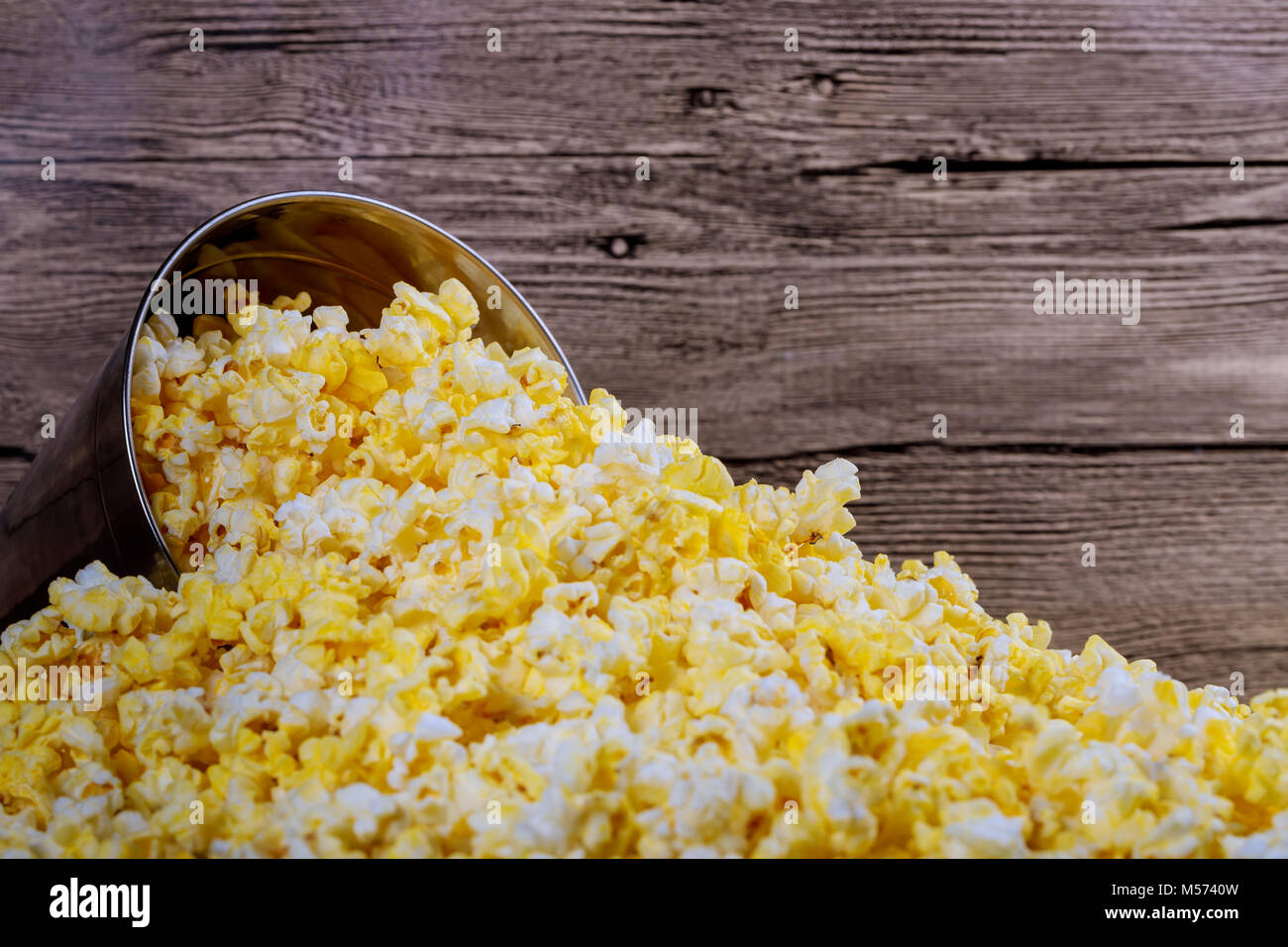Box of popcorn spilled on wood background Stock Photo - Alamy