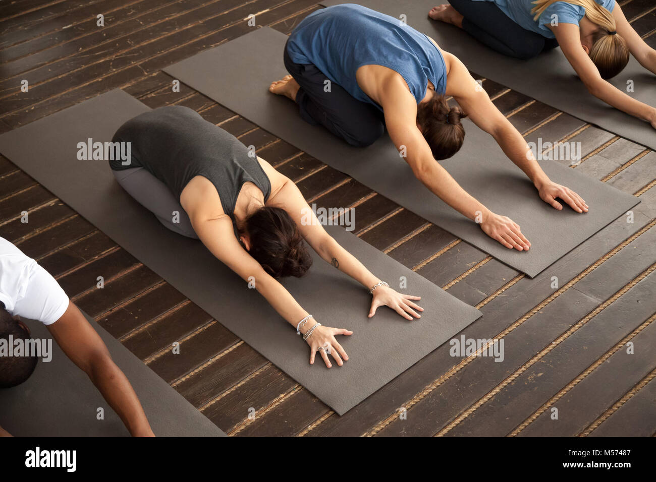 Group of yogi people in Child pose Stock Photo - Alamy