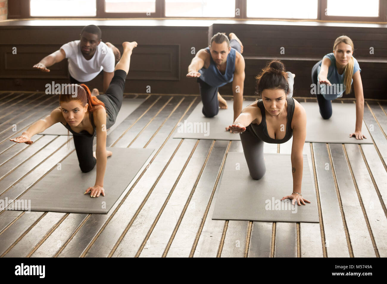 Group of sporty people in Donkey pose Stock Photo - Alamy