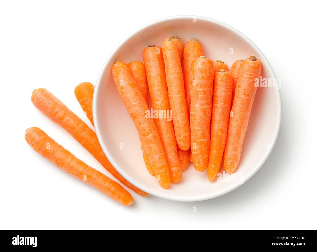 Baby, mini carrots in bowl isolated on white background. To view Stock ...